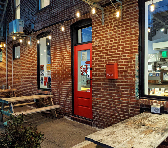 The red door stands out against the brick like a portal to seafood heaven, with rustic picnic tables outside for those perfect Baltimore summer evenings.