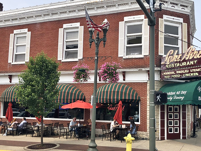 The corner spot where Lake Aire has been feeding Lake Geneva for generations, complete with flower baskets that add a touch of Wisconsin summer charm.