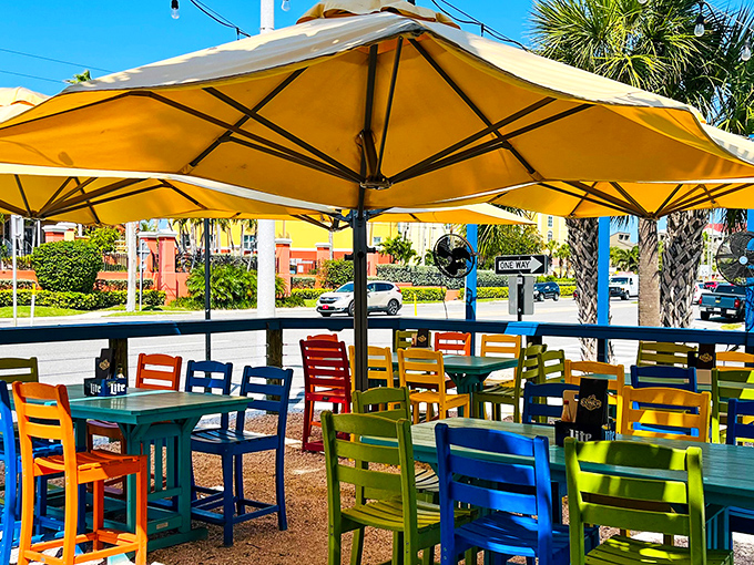 Rainbow-colored chairs under golden umbrellas create the perfect outdoor dining palette. Florida's sunshine is always on the menu.