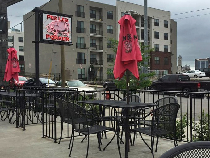 Outdoor seating with that iconic pig sign watching over you. Even Nashville's skyline seems to lean in for a whiff.