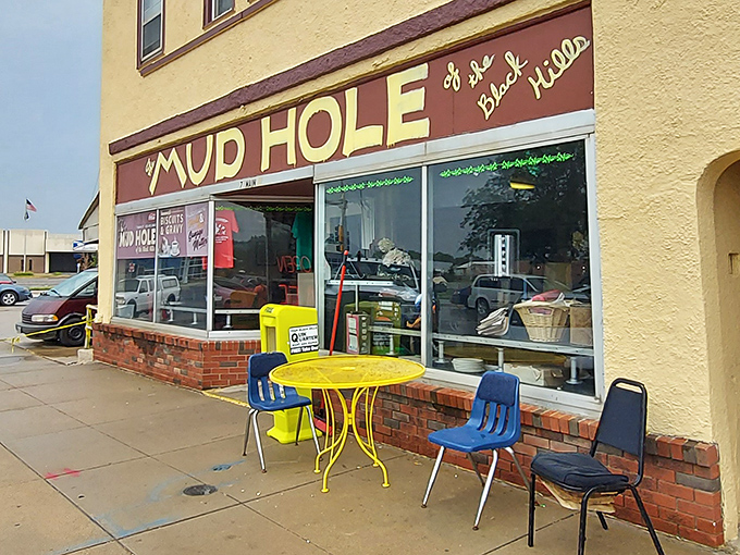 Sidewalk seating with character&mdash;a cheerful yellow table flanked by blue chairs that have seen their share of South Dakota seasons. Simple pleasures in the heart of Rapid City.