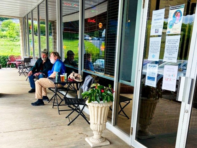 Outdoor seating where fresh air enhances every bite. Those simple metal chairs have hosted countless stories shared over satisfying meals.
