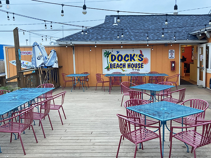 The outdoor deck, where blue tables and pink chairs create a playful palette for serious eating. Lake breezes included at no extra charge.