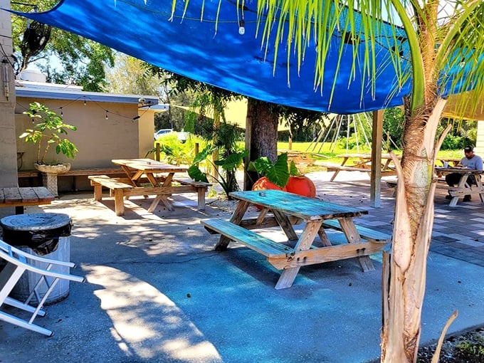 The outdoor picnic tables under blue tarps create the perfect Florida dining experience&mdash;casual, breezy, and ready for seafood feasting.