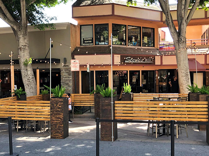 The outdoor seating area offers California dining at its most relaxed &ndash; sunshine, wooden benches, and the anticipation of barbecue bliss.