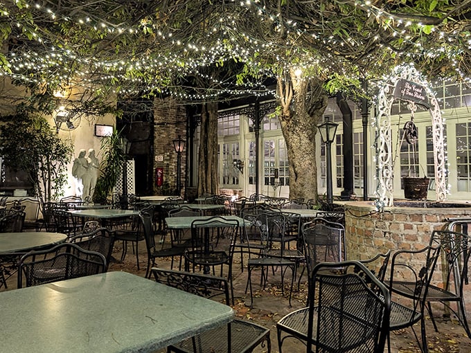 As night falls, the courtyard transforms into a twinkling wonderland where centuries-old trees stand guard over magical dining moments.