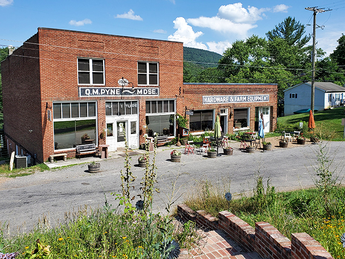 Outdoor seating surrounded by barrel planters, because sometimes your ribeye needs a side of fresh mountain air.