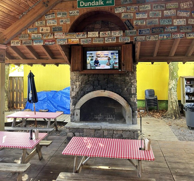The outdoor seating area, where license plates from visitors far and wide create a ceiling of pilgrimage proof above the picnic tables.