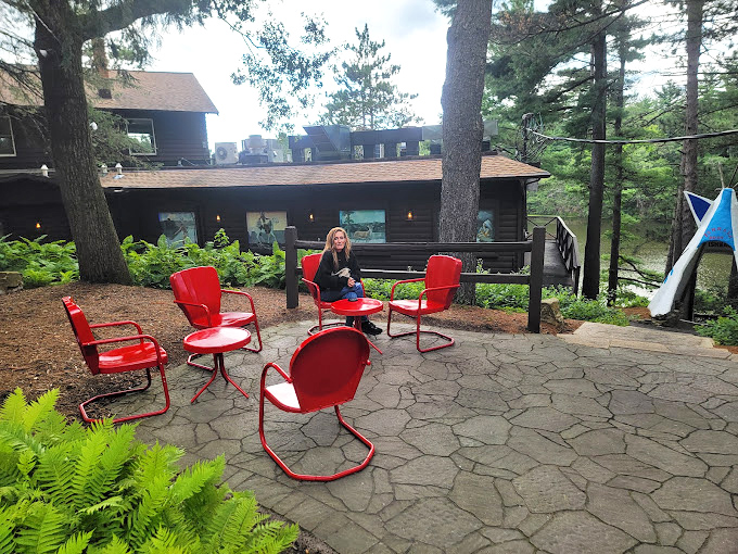 Red metal chairs invite you to linger outside, where the forest-to-table distance can be measured in footsteps rather than miles.