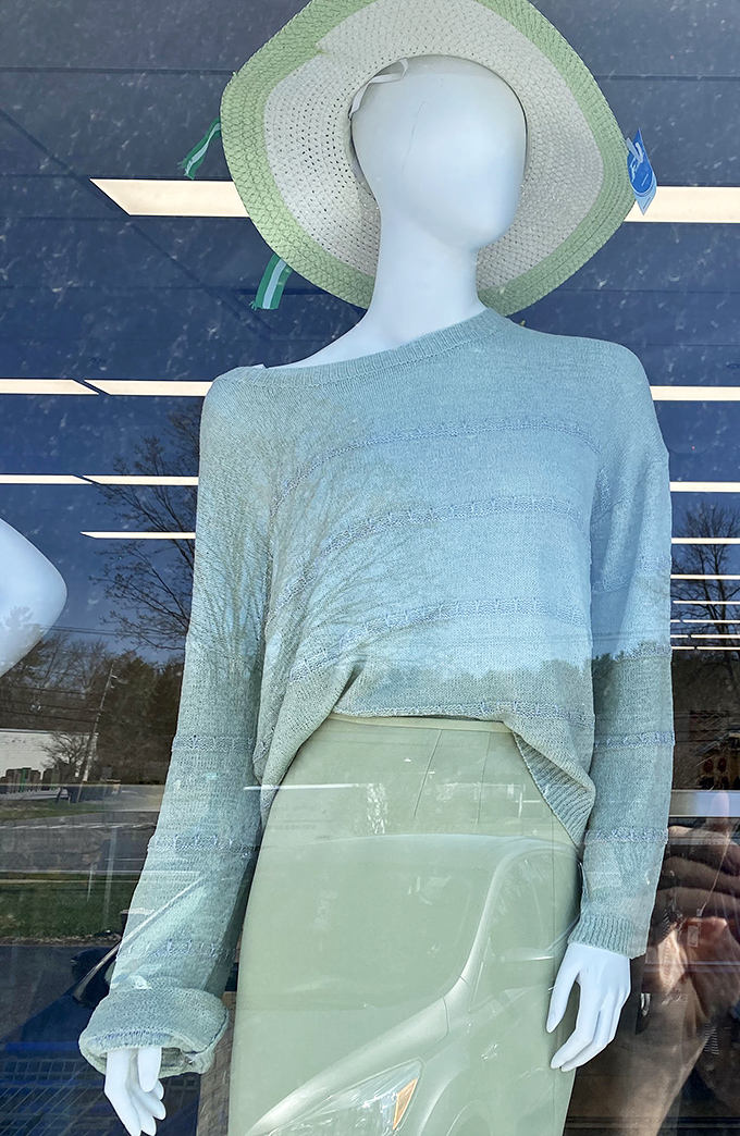 This mint-green ensemble in the window display could easily be mistaken for a boutique offering, not a thrifted treasure waiting to be discovered.