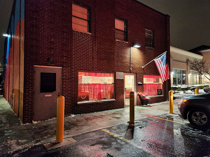 As night falls, the brick building stands as a beacon of culinary constancy in a world of ever-changing food trends.