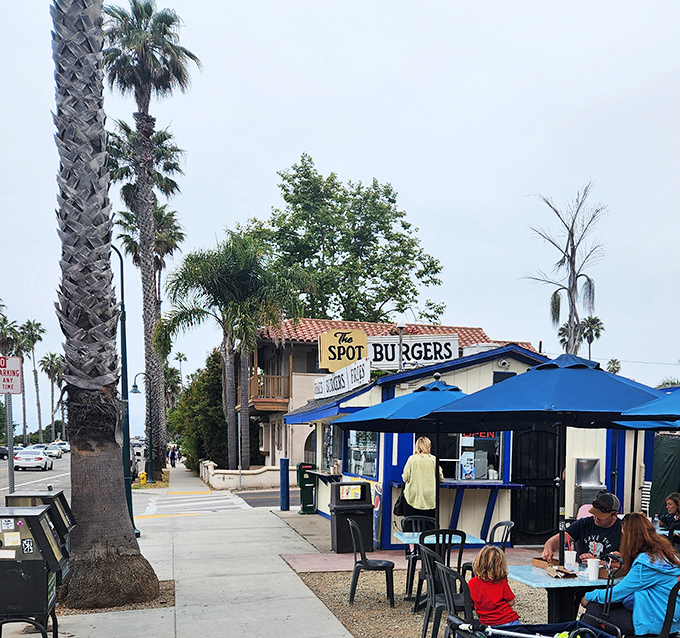 Blue umbrellas provide shade for diners enjoying their feast in the eternal California sunshine.