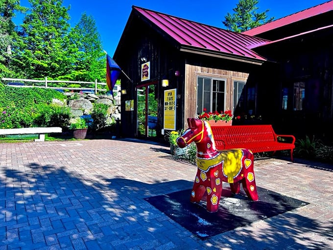 A colorful welcome committee greets visitors outside, promising whimsy before you even step through the red-trimmed door.