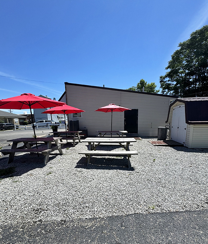 Red umbrellas dot the outdoor seating area, offering shade for those summer days when a burger pilgrimage demands al fresco appreciation.