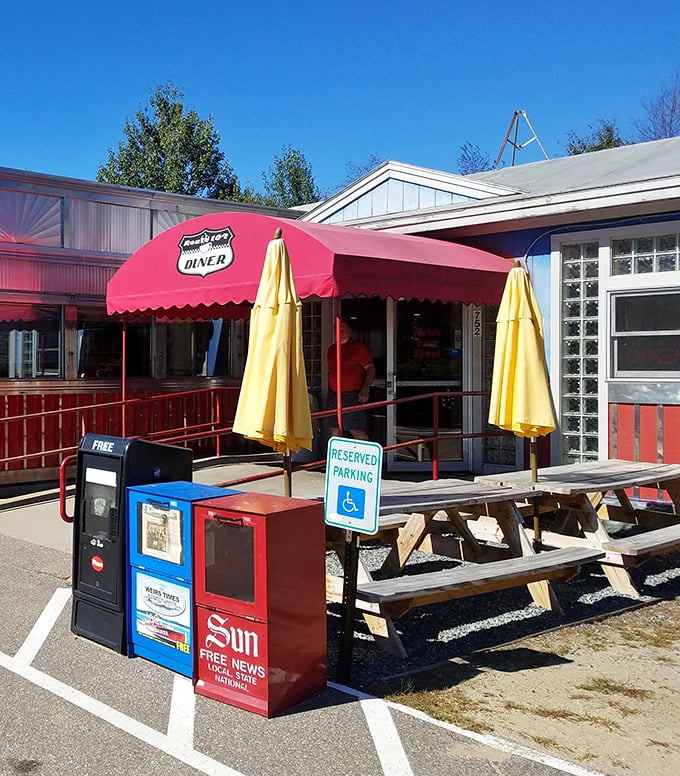 Outdoor seating for when your comfort food coma requires fresh air. Those picnic tables have heard more satisfied sighs than a therapist's couch.