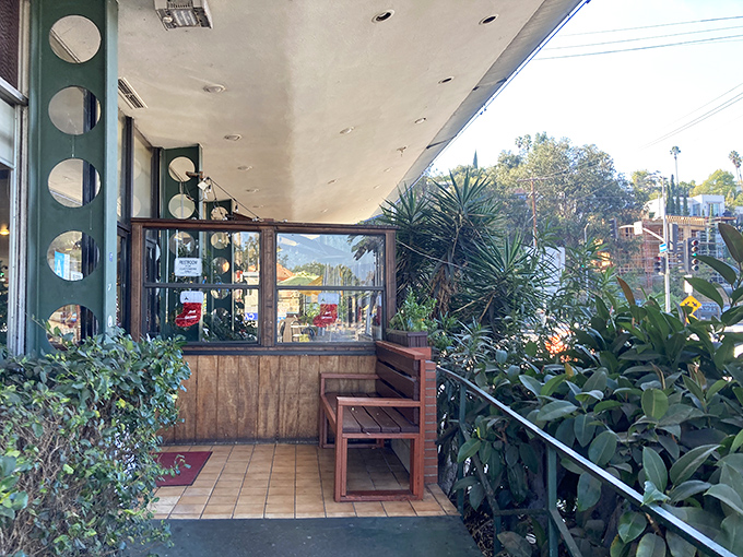 The entrance welcomes you like an old friend, promising that whatever chaos exists outside, inside awaits the reliable comfort of good food and zero judgment.