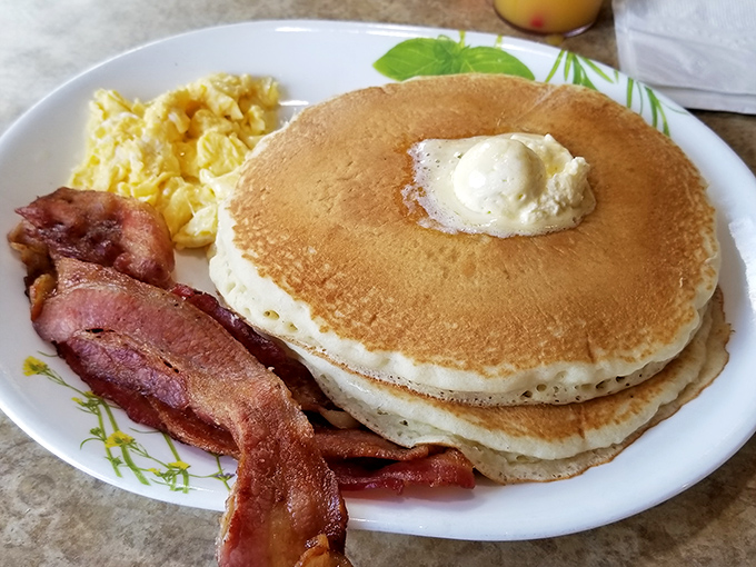 Pancakes so perfectly golden they make the sun jealous, with butter melting into that sweet, fluffy landscape of breakfast bliss.