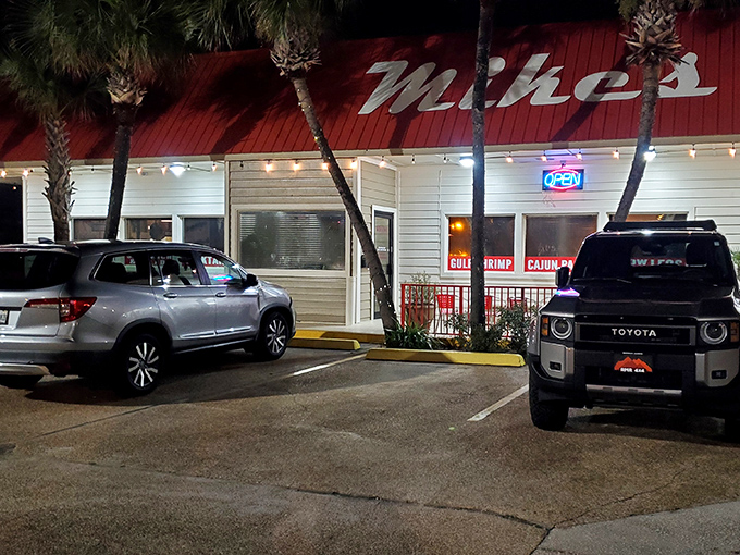 As evening falls, Mike's transforms from sunny seafood joint to glowing nighttime oasis. The neon promises comfort waiting just inside.
