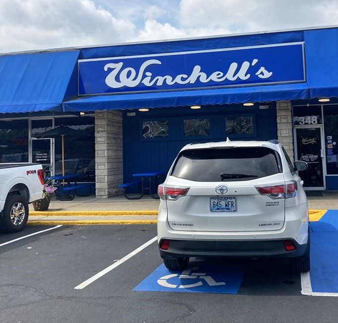 The blue handicap spot perfectly matches Winchell's signature awning&mdash;even the parking lot stays on brand in this beloved Lexington institution.