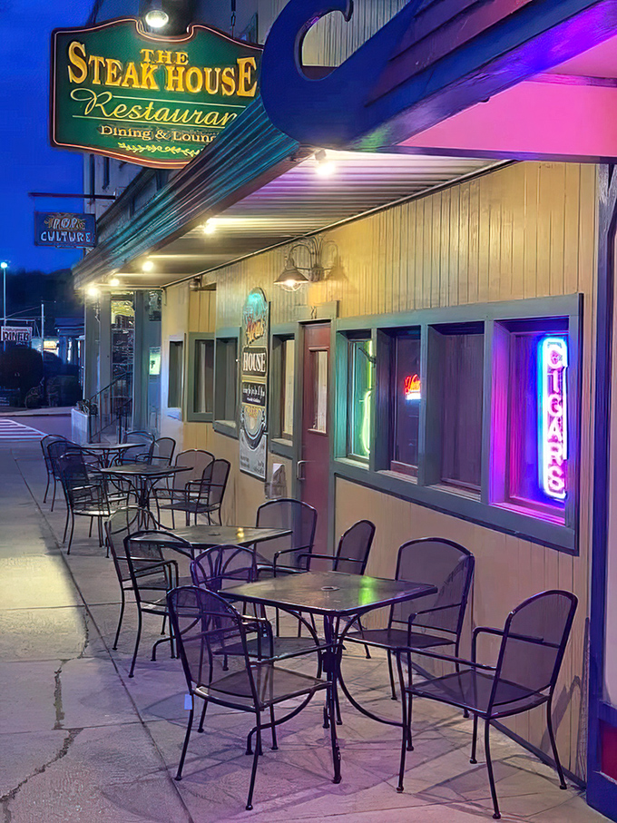 As evening falls, the patio transforms into a neon-lit oasis where summer nights and sizzling steaks create memories that outlast the season.