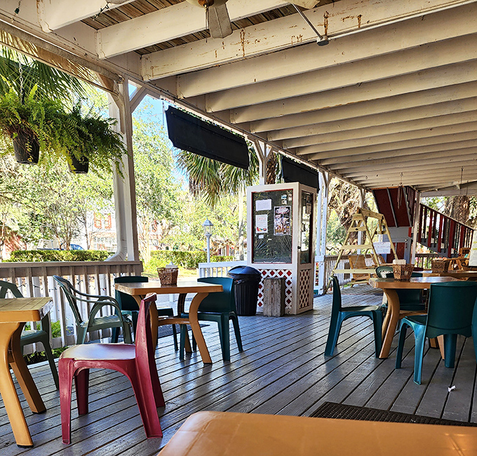 The porch dining area offers the kind of authentic Florida experience that no theme park could ever replicate&mdash;just good food, fresh air, and zero animatronics.
