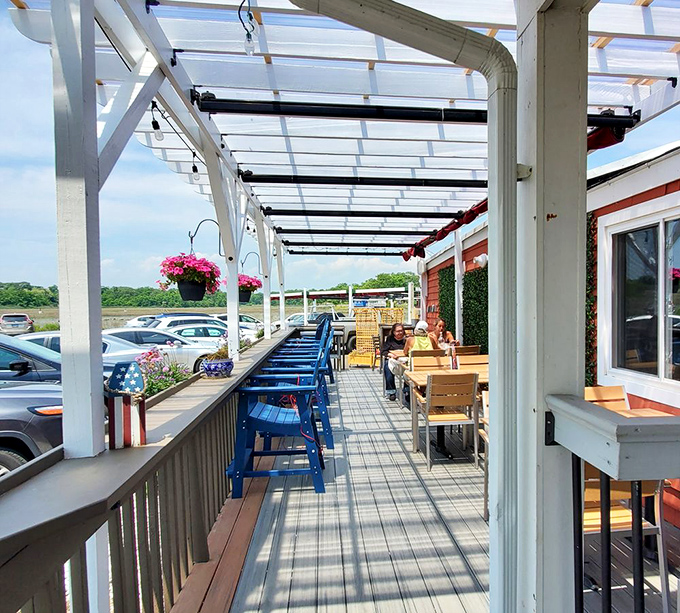 The outdoor patio—where fresh air enhances every bite and those blue chairs practically demand you stay for "just one more" appetizer.