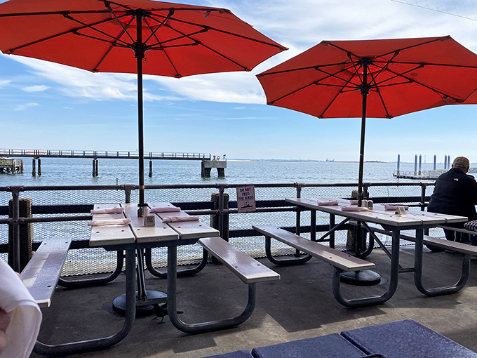 The outdoor patio where fresh air comes complimentary with every order, and orange umbrellas stand guard against the Carolina sunshine.
