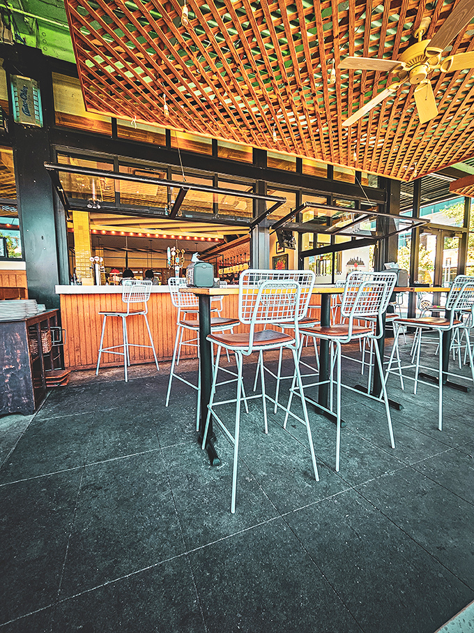 Bar seating beneath a latticed ceiling where pizza pilgrims can worship at the altar of craft beverages.