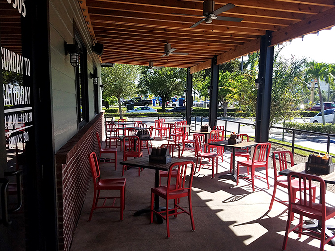 The outdoor patio with its bright red chairs offers a sunny spot to enjoy your barbecue while contemplating absolutely nothing important whatsoever.