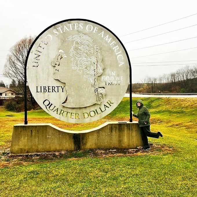 Playful poses with the Giant Quarter have become something of a tradition&mdash;this visitor appears to be keeping Washington on his toes.