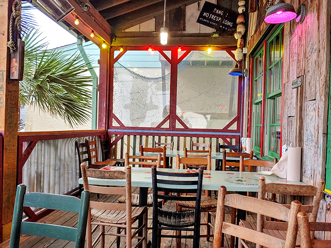 Screened porch dining that captures that perfect coastal vibe &ndash; where salt air mingles with the scent of fried seafood and vacation mode activates instantly.