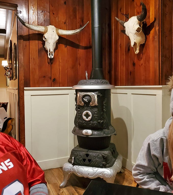 Vintage potbelly stove and longhorn skulls nod to North Dakota's ranching heritage, creating atmosphere you simply can't manufacture with modern design tricks.