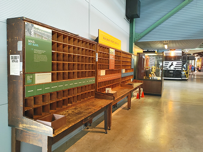 The railway post office exhibit showcases the wooden sorting cases where mail clerks performed their high-speed organizational magic.
