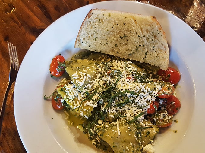 Ravioli bathed in pesto that would make an Italian grandmother nod in approval. That garlic bread isn't a side&mdash;it's an essential dining companion.