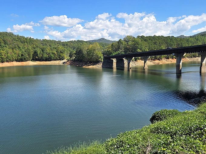 The railroad bridge spans calm waters, creating reflections that photographers dream about and the rest of us just enjoy immensely.