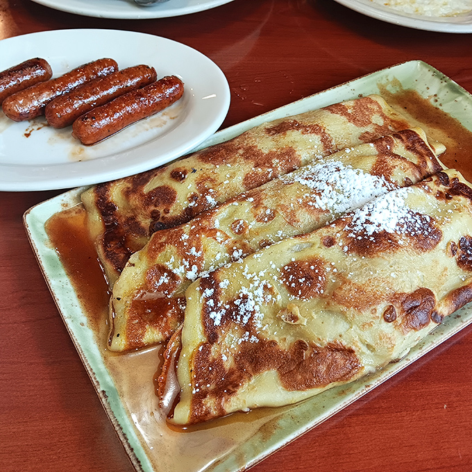 These rolled pancakes aren't just breakfast, they're an engineering marvel with a sweet disposition and powdered sugar snowcap.