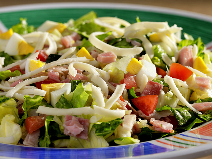 This isn't just a salad; it's a colorful celebration of freshness. The ribbons of cheese and ham transform ordinary vegetables into something worth talking about.