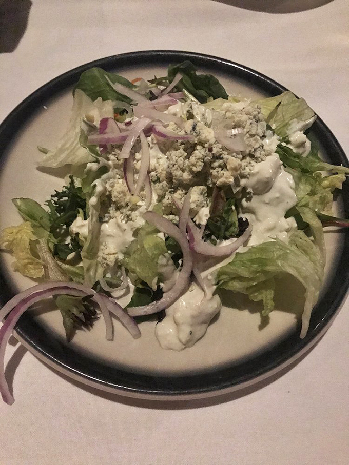 A house salad that defies steakhouse stereotypes &ndash; crisp, thoughtful, and adorned with just the right amount of blue cheese.