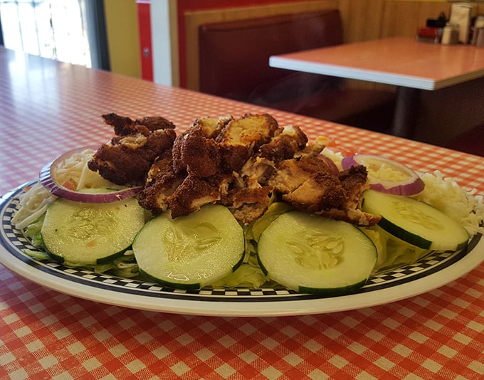 Crispy chicken atop fresh cucumber slices&mdash;proof that sometimes diners do vegetables without deep-frying them first.