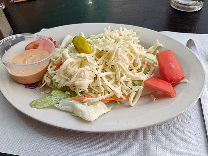 A simple house salad with shredded cheese and thousand island dressing &ndash; the perfect opening act before the pizza headliner.