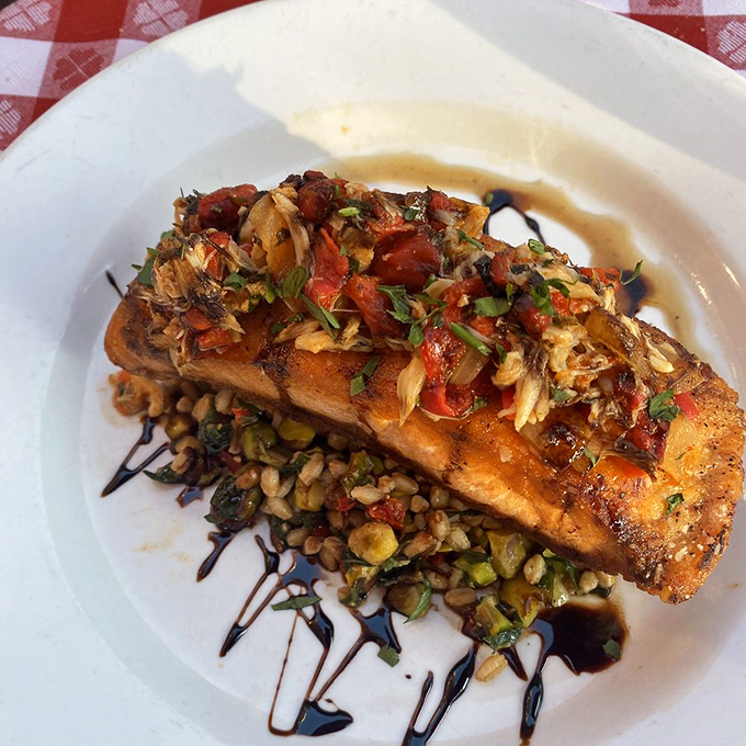 Salmon that's dressed for success&mdash;seared to perfection and topped with a confetti of tomatoes and herbs over what appears to be farro.