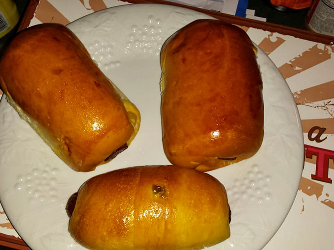 Kolaches that look like edible pillows stuffed with savory goodness. The golden-brown exterior promises a perfect chew with each delicious bite.