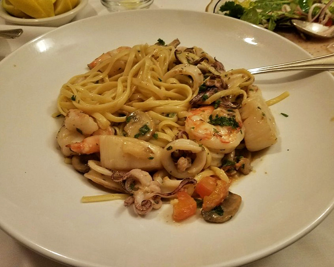 Seafood linguine that makes you wonder why anyone would waste pasta on anything else—a tangle of noodles playing host to an underwater party.