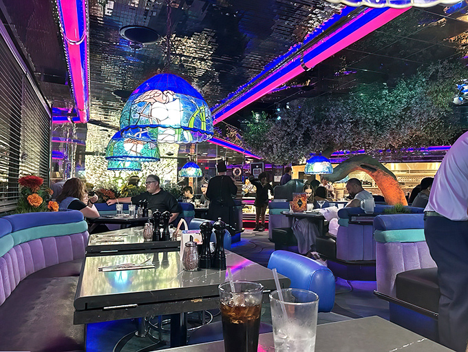 Purple banquettes and neon lighting create the kind of atmosphere where every meal feels like a celebration of pure indulgence.