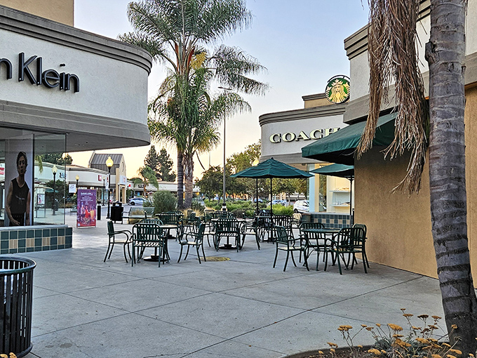 Palm trees and patio seating between Coach and Calvin Klein create a shopping oasis where caffeine refueling meets people-watching.