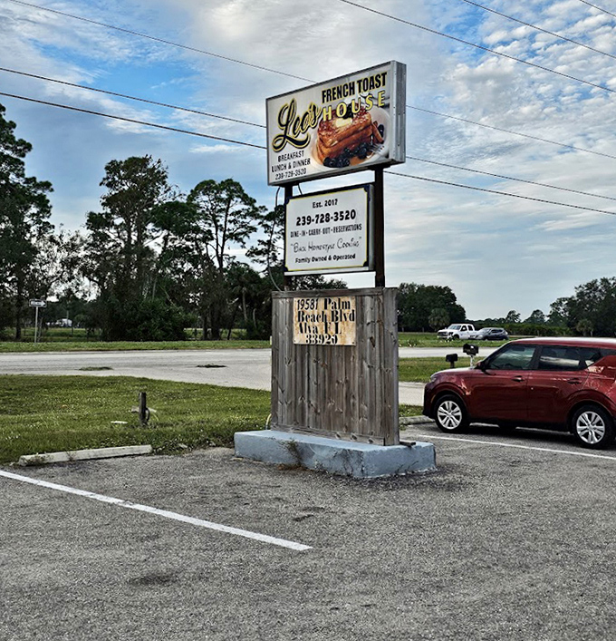 The roadside sign stands tall, a beacon for hungry travelers promising French toast salvation just off Palm Beach Boulevard.