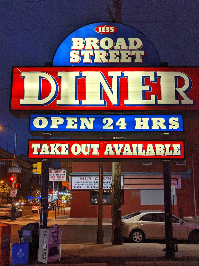 The neon sign glows like a lighthouse in the night, promising "OPEN 24 HRS" when hunger strikes at impossible hours.