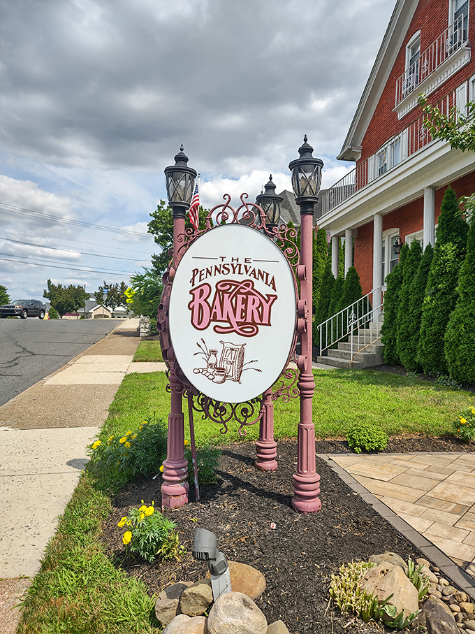 The entrance sign stands like a pink-pillared gateway to Narnia, except instead of talking lions, you'll find talking-worthy pastries.