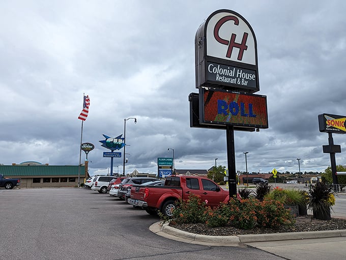 Even on cloudy days, the Colonial House sign shines bright, promising "DOWN HOME COOKING" that delivers on every syllable of that pledge.