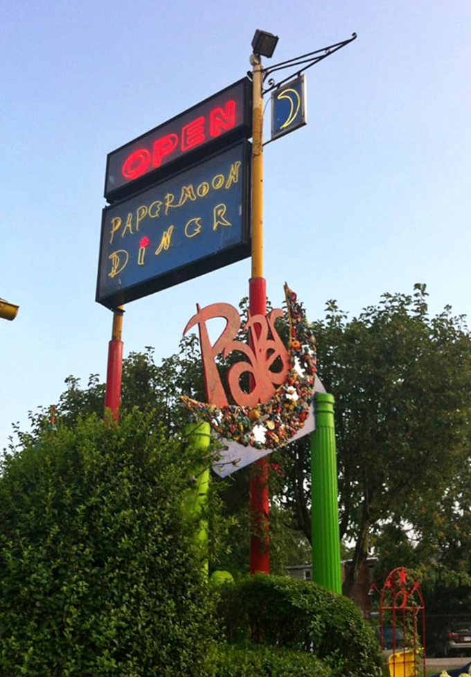The PaperMoon sign stands tall, a beacon of quirky dining in a world of restaurant conformity. Follow the neon to find the fun.